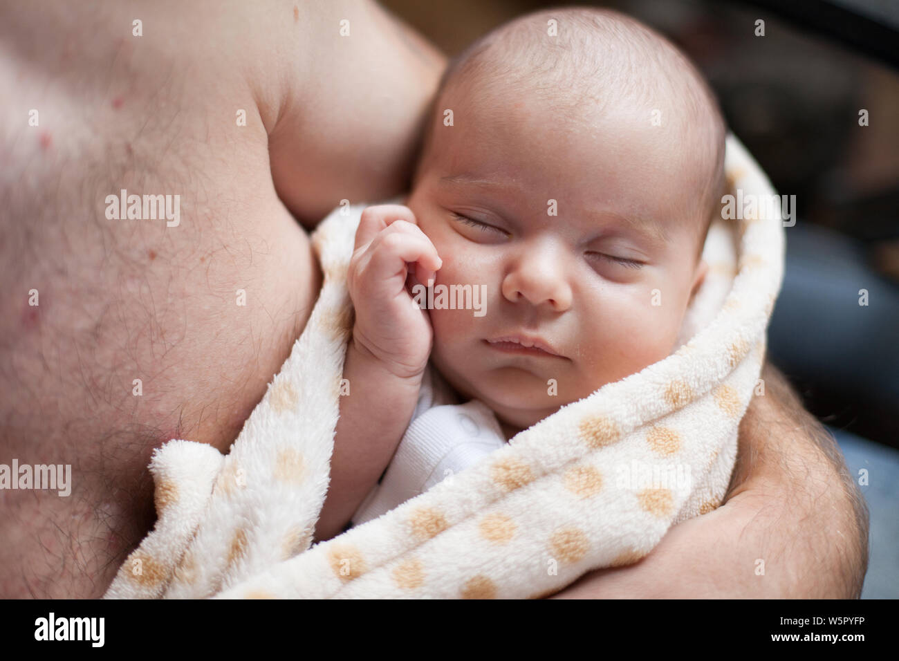 Young father holding his sweet adorable sleeping newborn child Stock Photo - Alamy