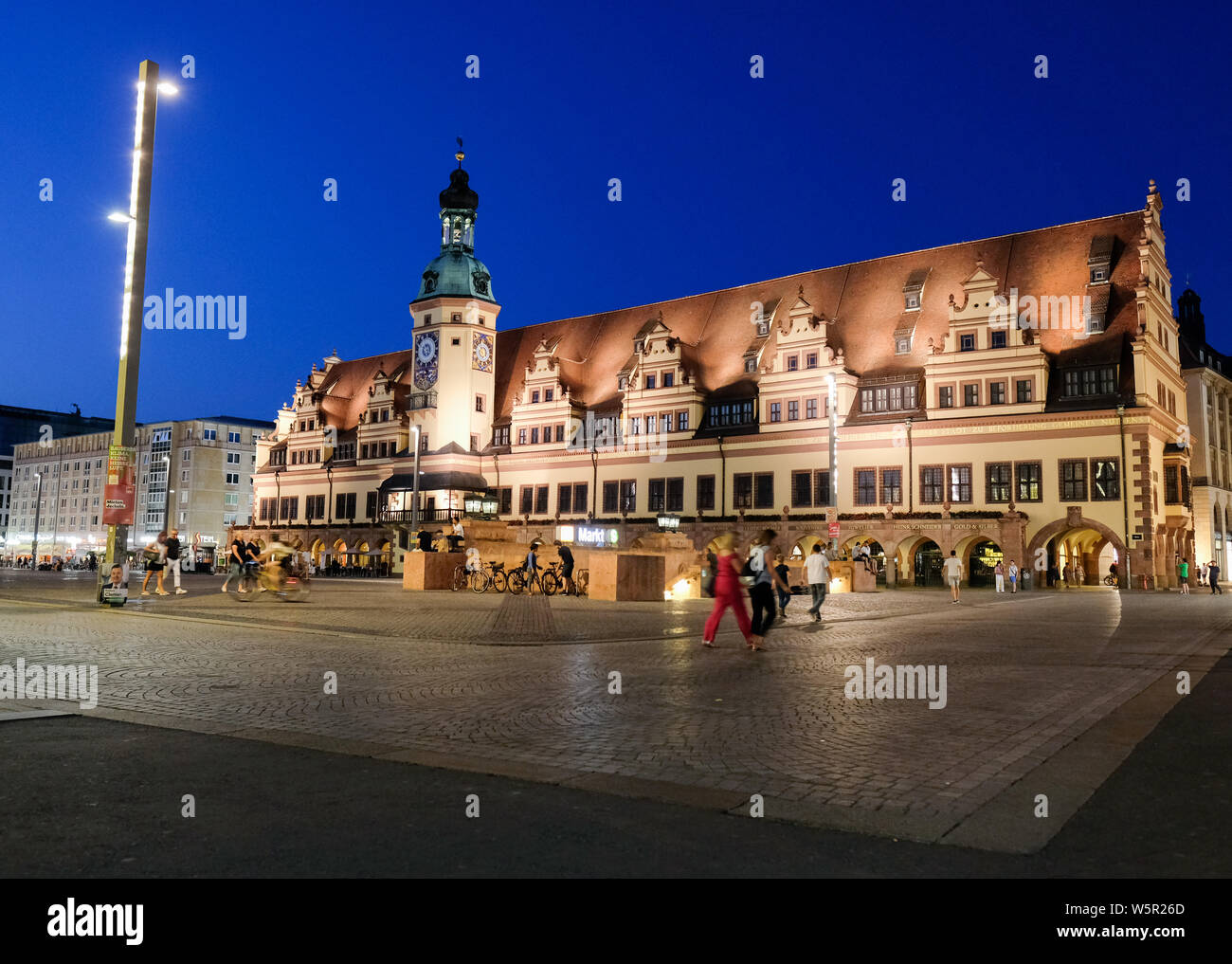 Leipzig, Germany. 25th July, 2019. In the evening passers-by walk past ...