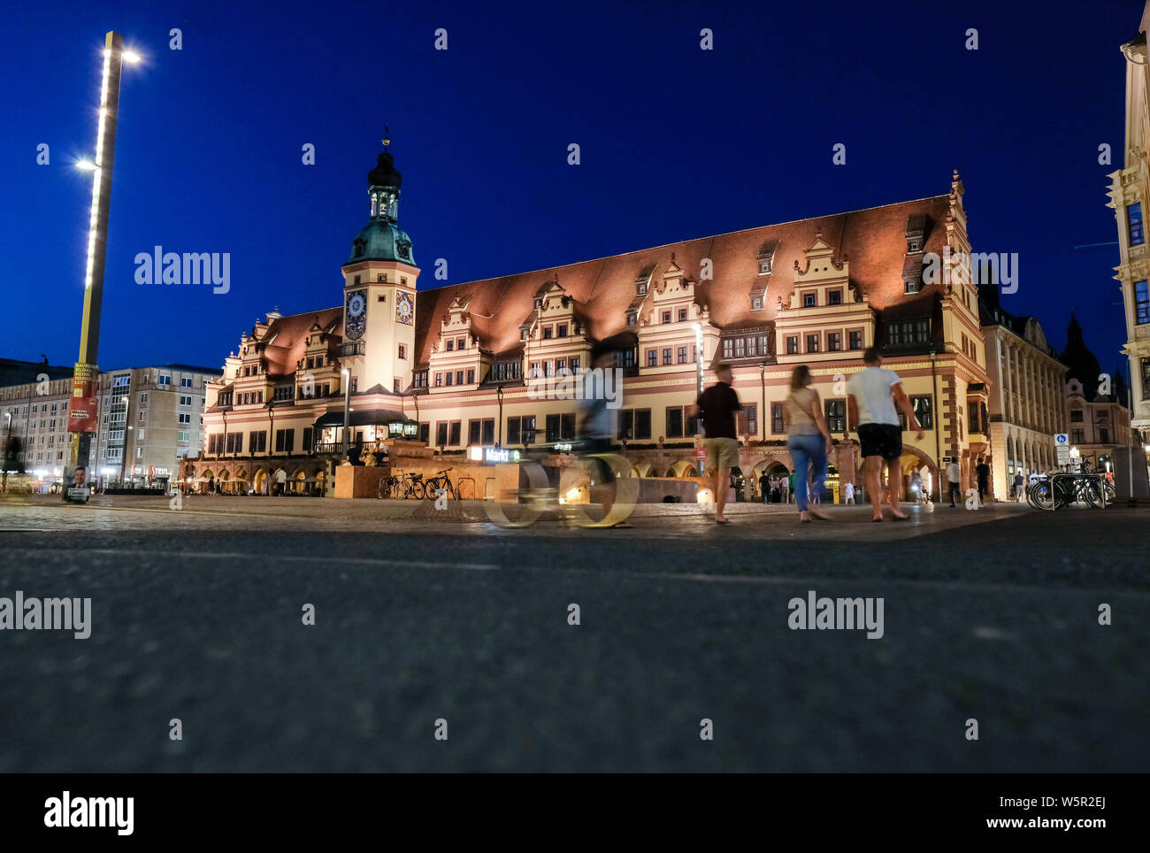 Leipzig, Germany. 25th July, 2019. In the evening passers-by walk past ...