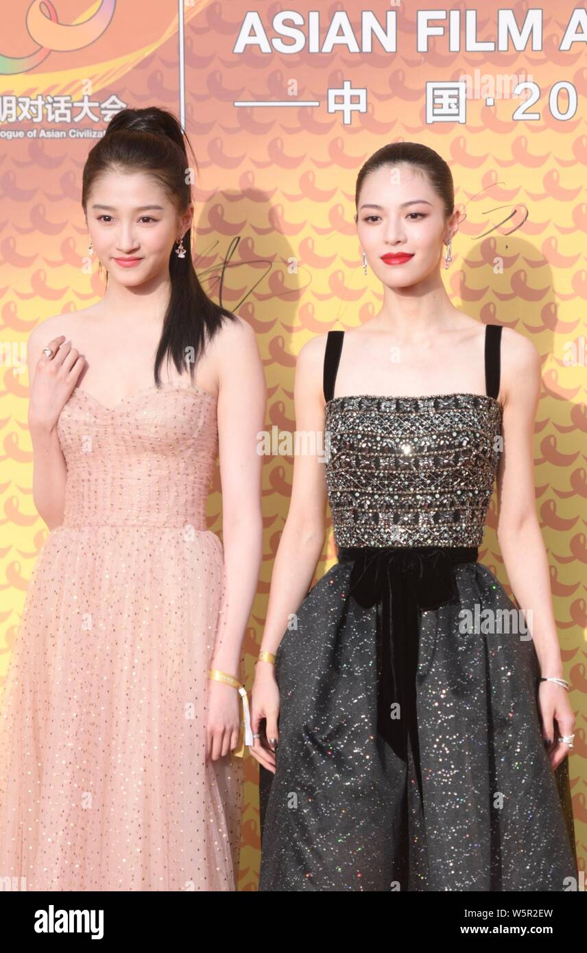 Chinese actresses Guan Xiaotong, left, and Zhong Chuxi pose as they arrive on the red carpet for ...