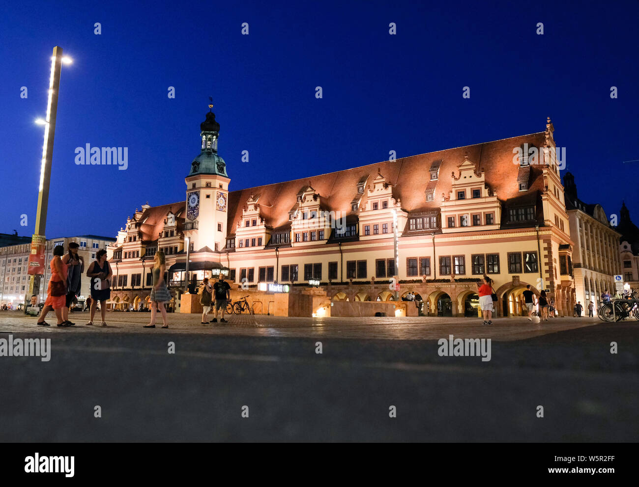 Leipzig, Germany. 25th July, 2019. In the evening passers-by walk past ...