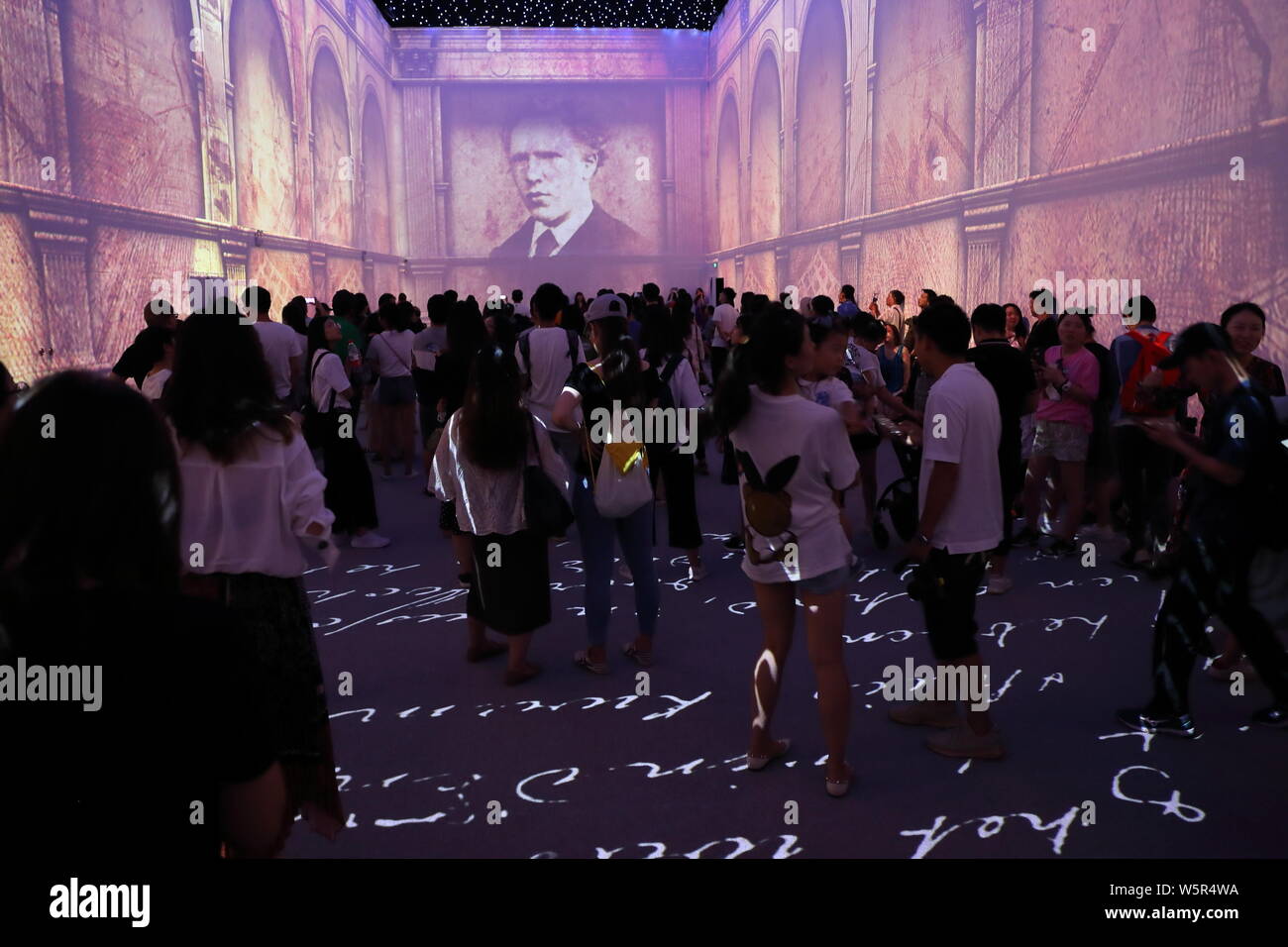 Visitors view or take pictures of a projection of art by Dutch post ...