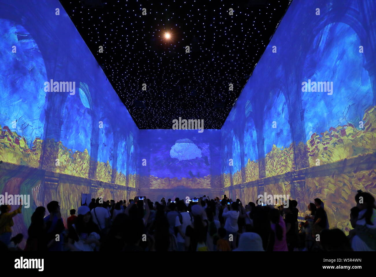 Visitors view or take pictures of a projection of art by Dutch post ...