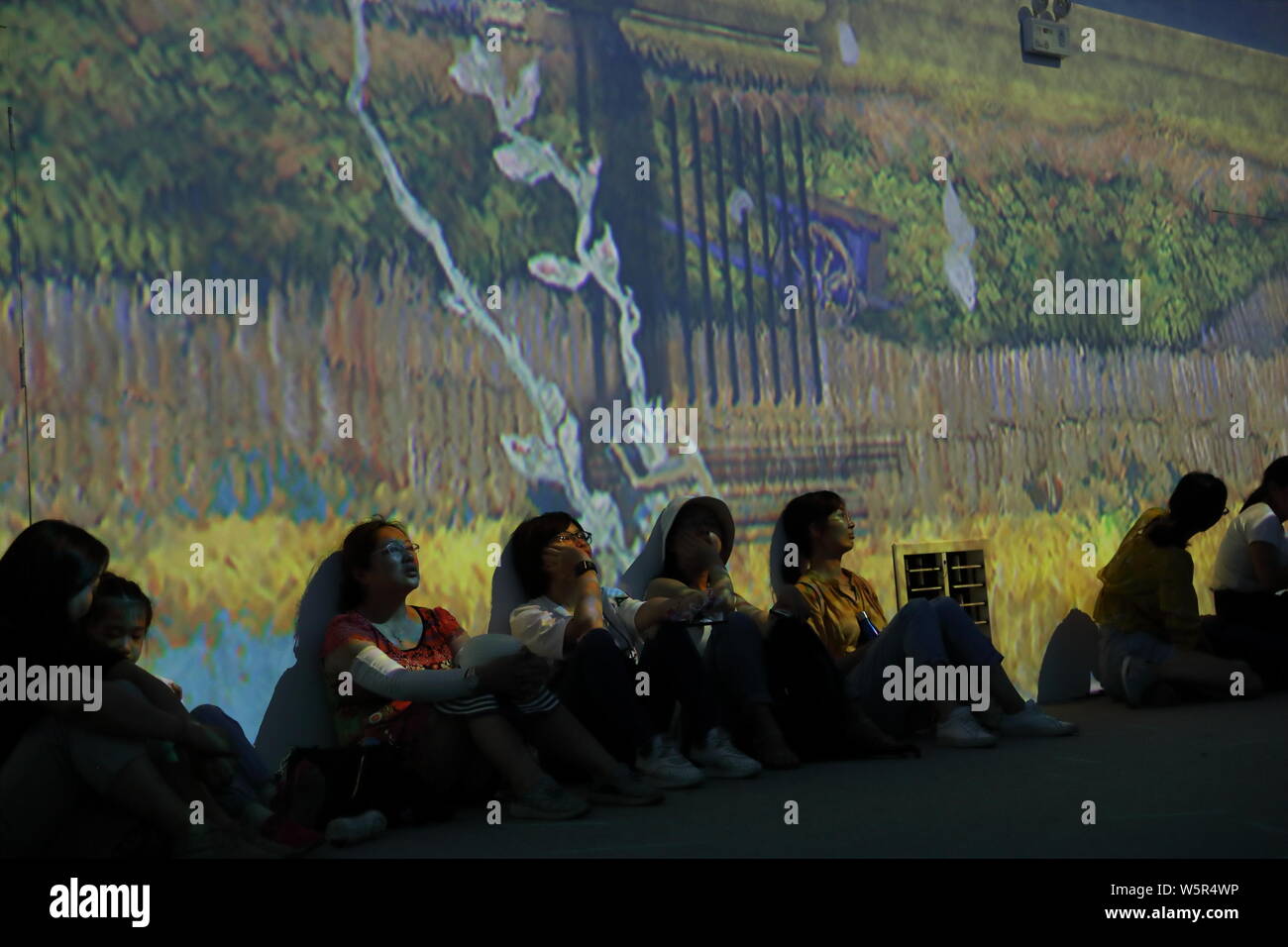 Visitors view a projection of art by Dutch post-impressionist painter ...