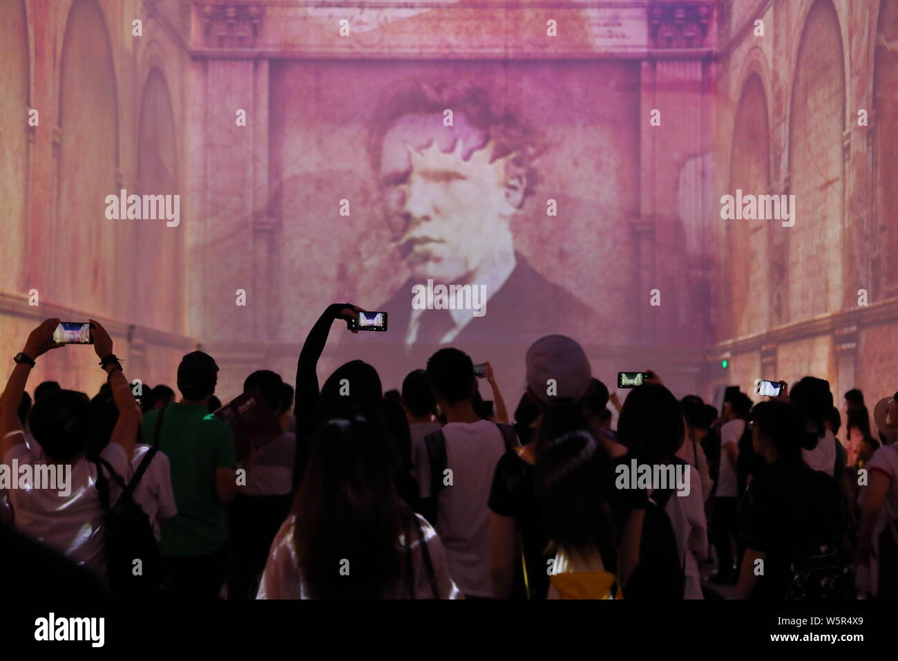 Visitors view or take pictures of a projection of art by Dutch post ...