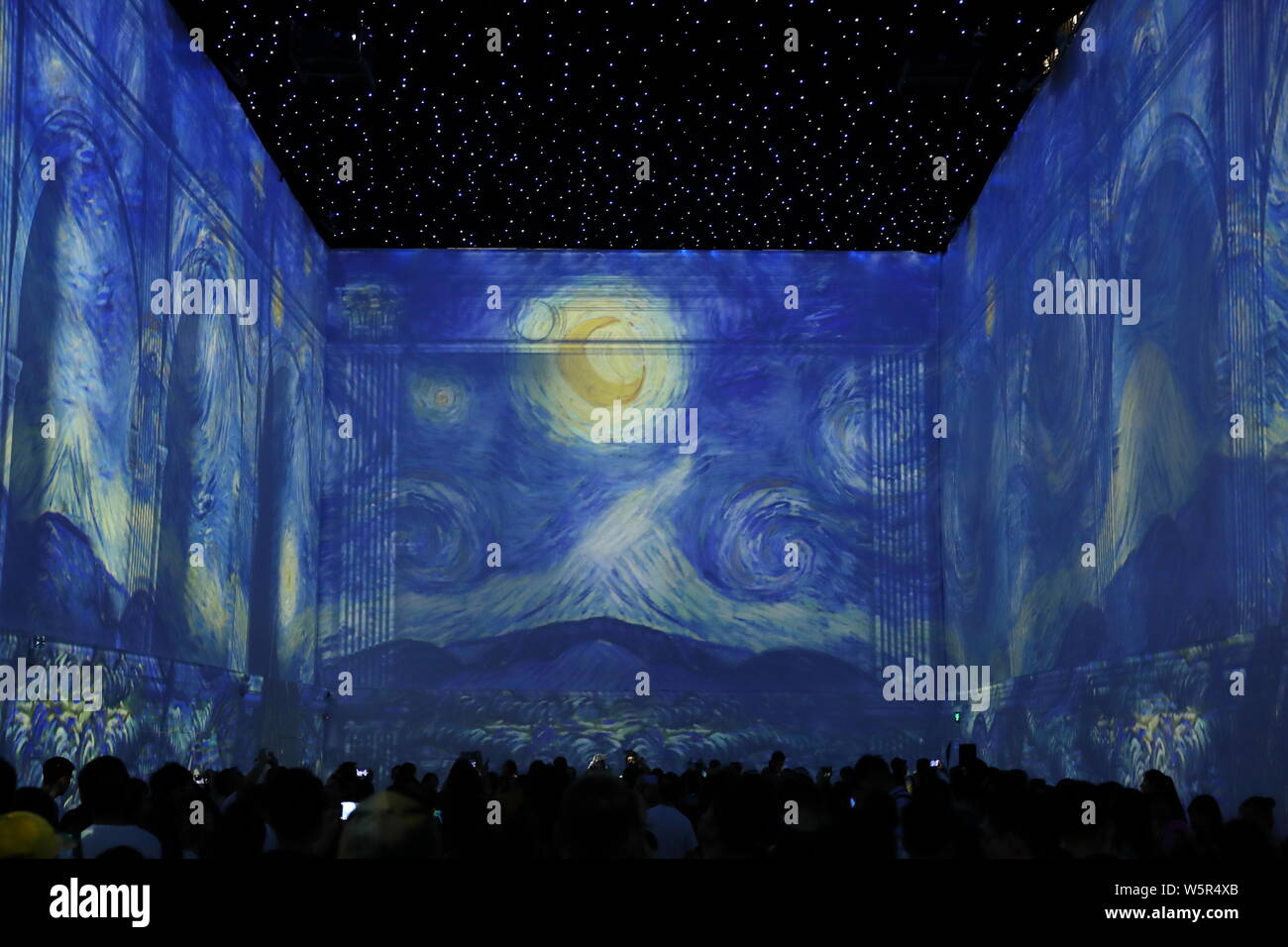 Visitors view or take pictures of a projection of art by Dutch post ...