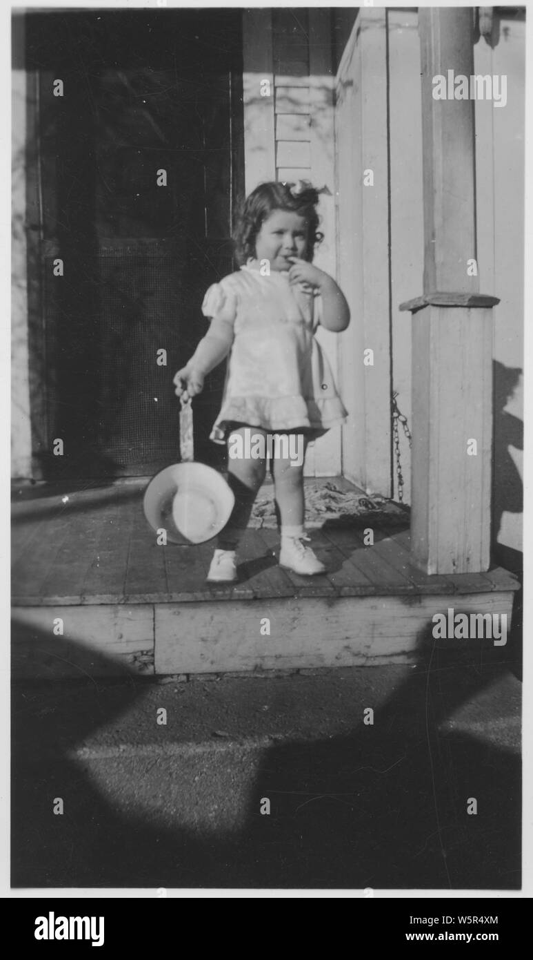 Little girl holding pot; Scope and content: The little girl is holding ...