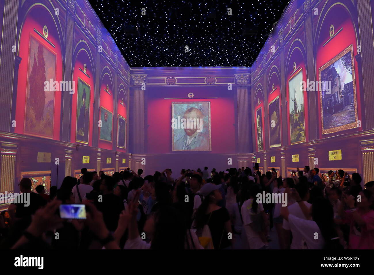 Visitors view or take pictures of a projection of art by Dutch post ...