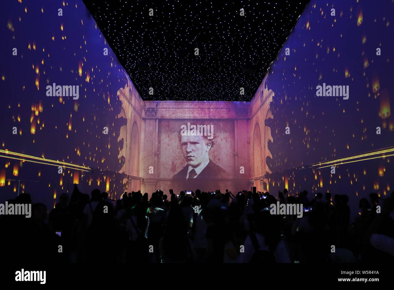 Visitors view or take pictures of a projection of art by Dutch post ...