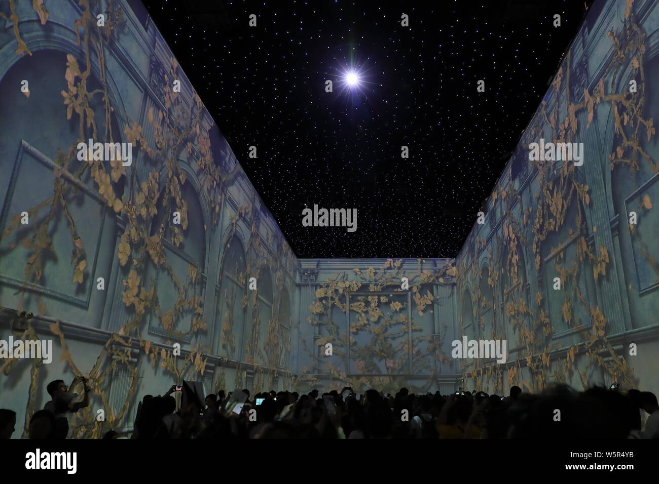 Visitors view or take pictures of a projection of art by Dutch post ...