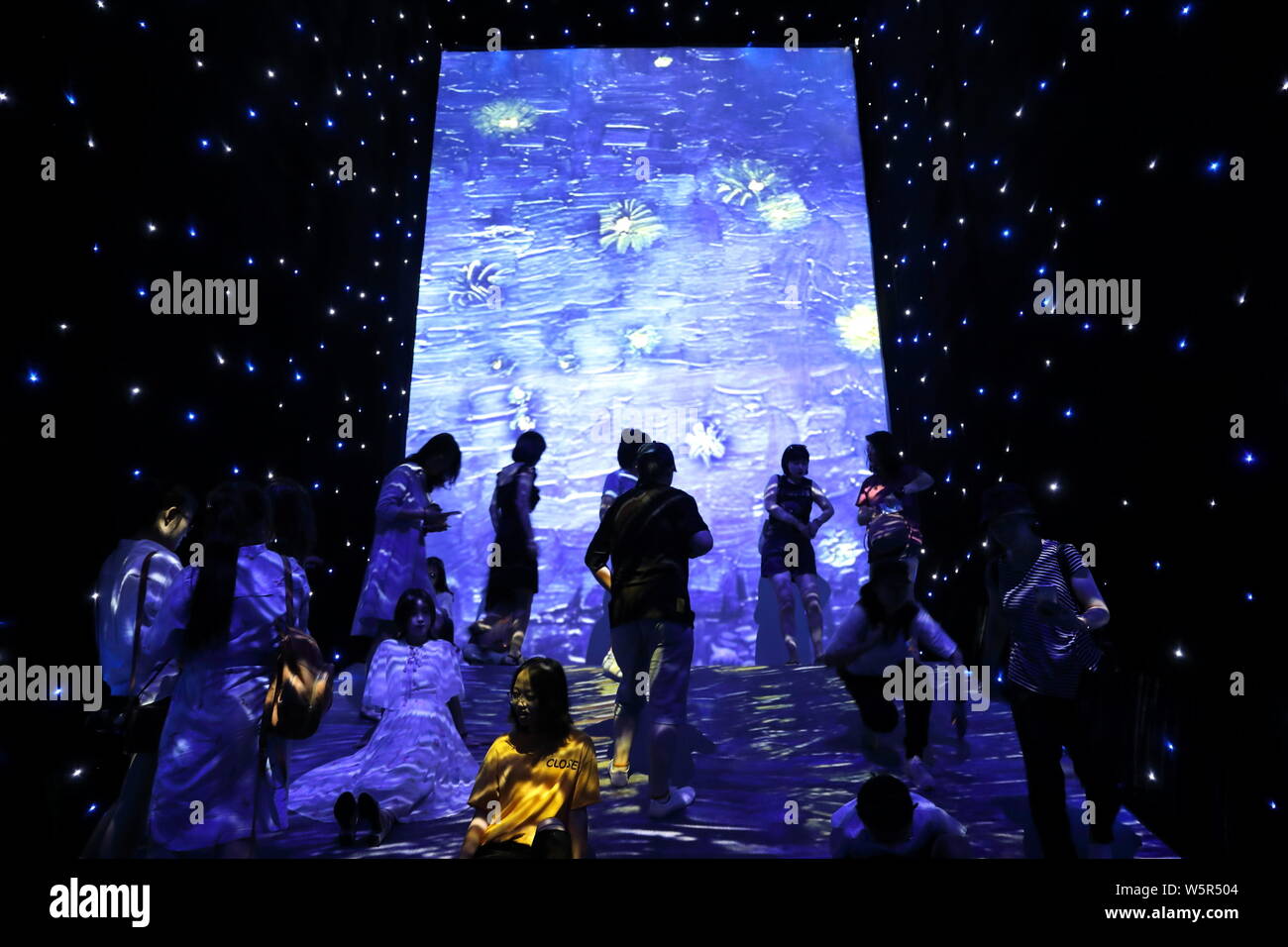 Visitors view a projection of art by Dutch post-impressionist painter ...