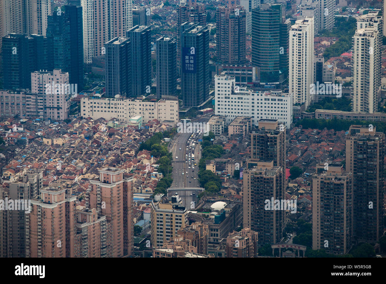 Residential houses in longtang are embraced by skyscrapers and high ...