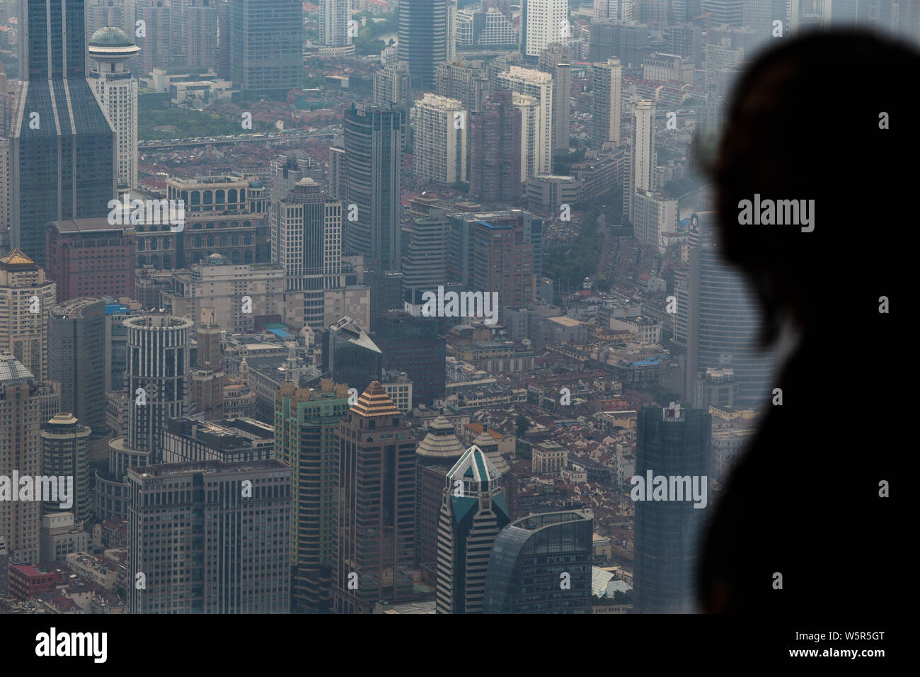 Residential houses in longtang are embraced by skyscrapers and high ...