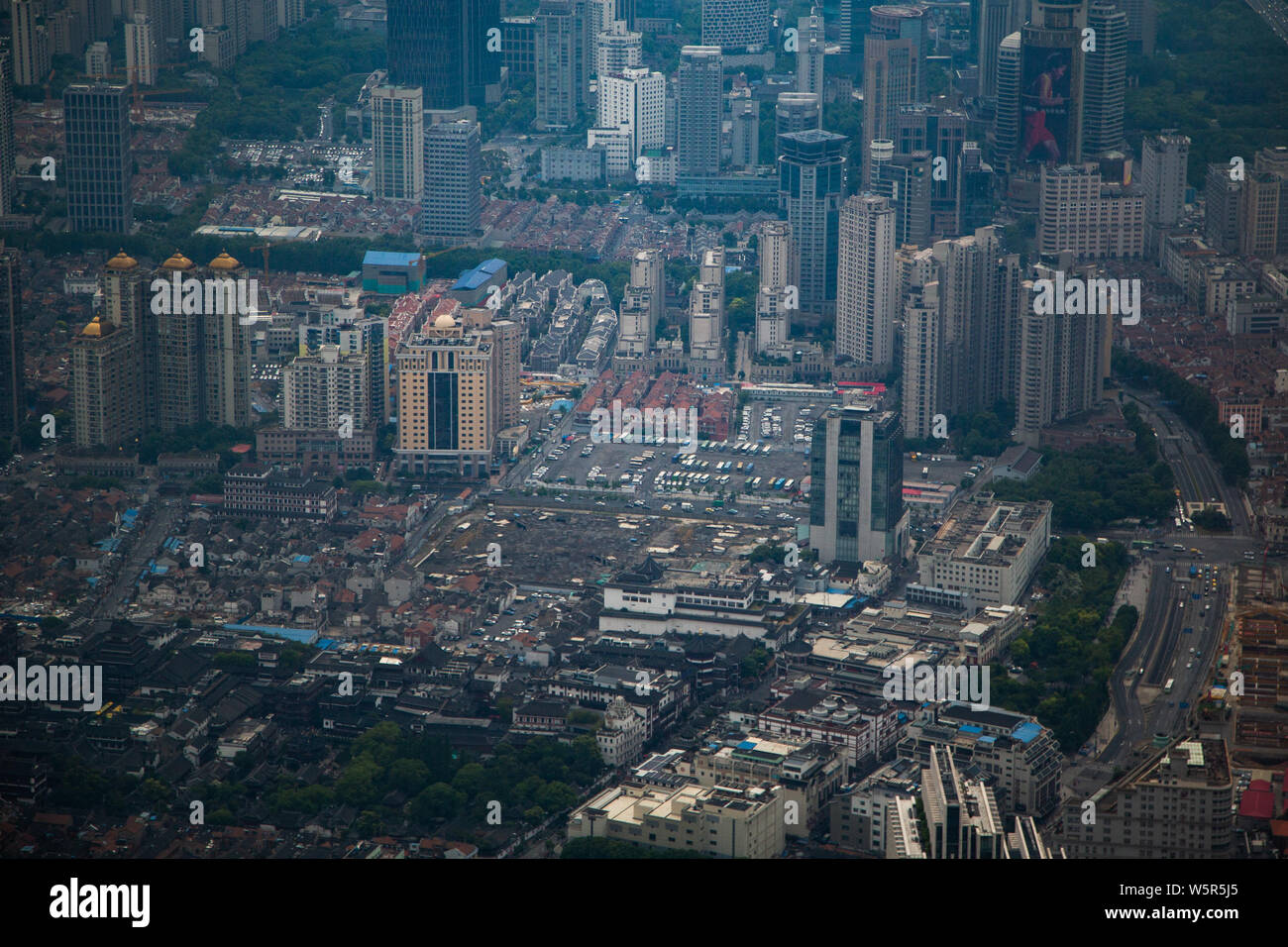 Residential houses in longtang are embraced by skyscrapers and high ...