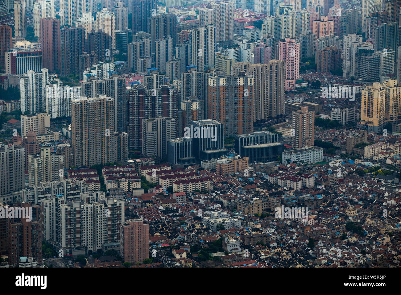 Residential houses in longtang are embraced by skyscrapers and high ...