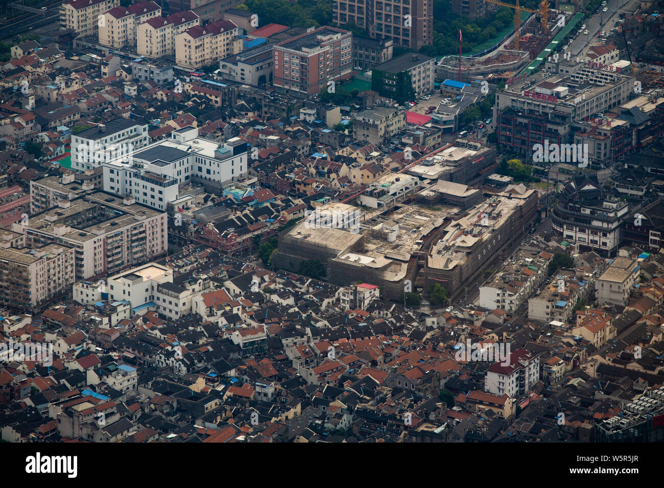 Residential houses in longtang are embraced by skyscrapers and high ...