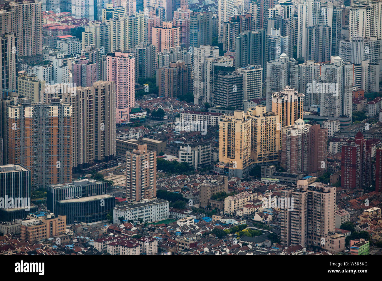 Residential houses in longtang are embraced by skyscrapers and high ...