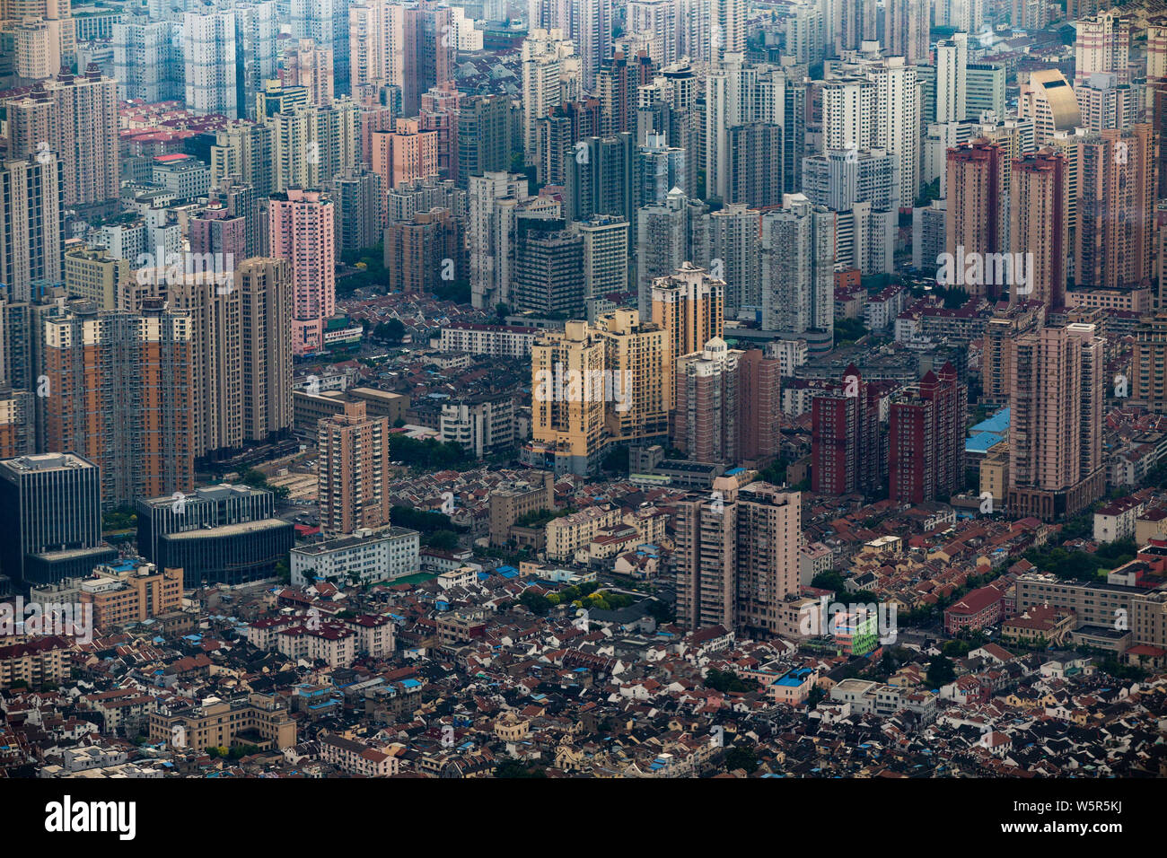 Residential houses in longtang are embraced by skyscrapers and high ...