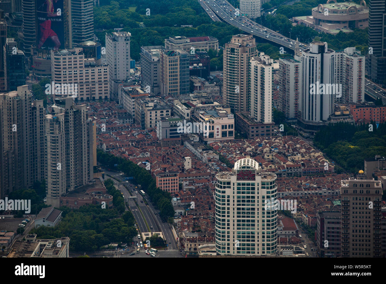 Residential houses in longtang are embraced by skyscrapers and high ...