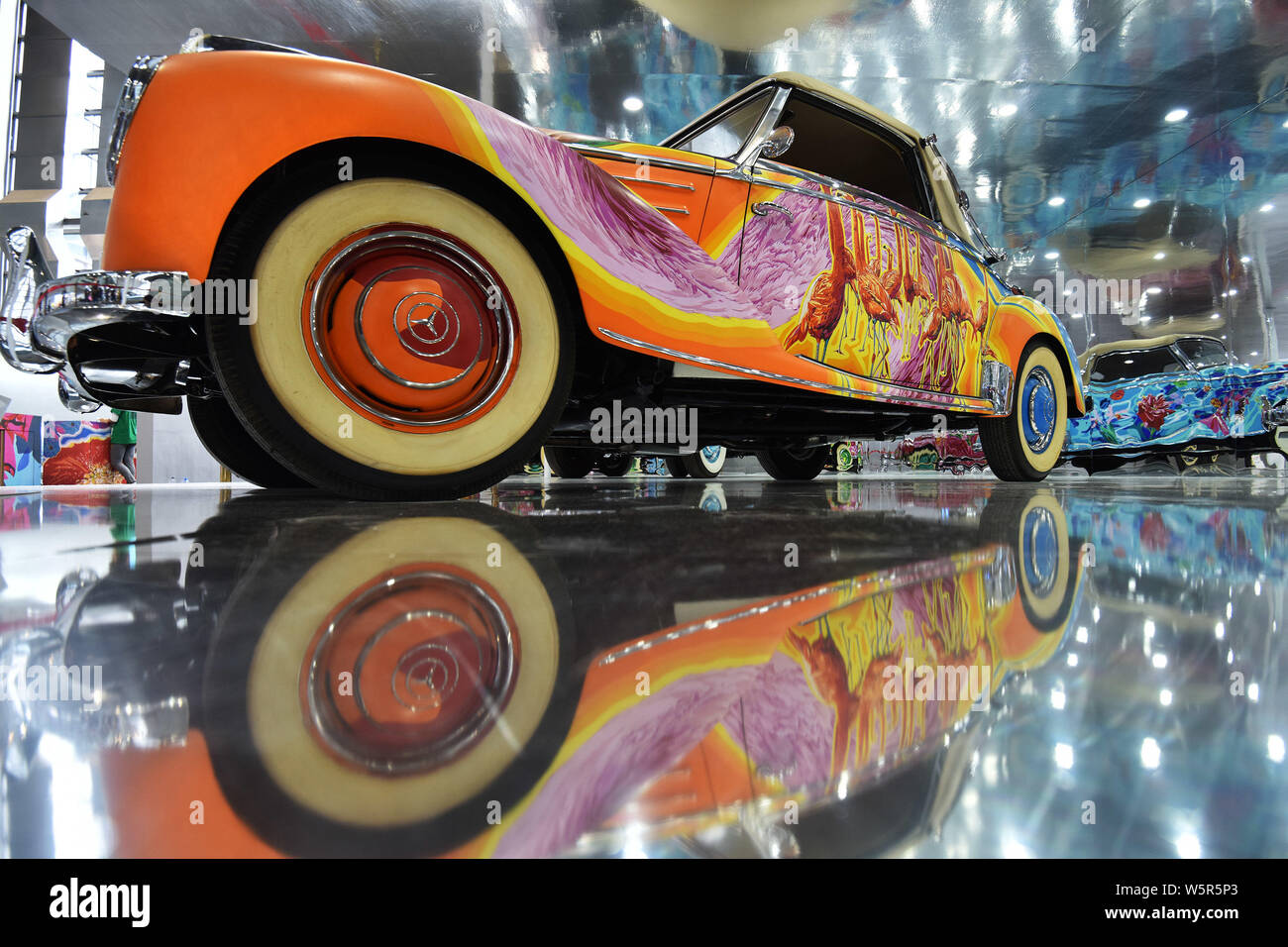 Vintage vehicles covered with colorful oil painting images are ...