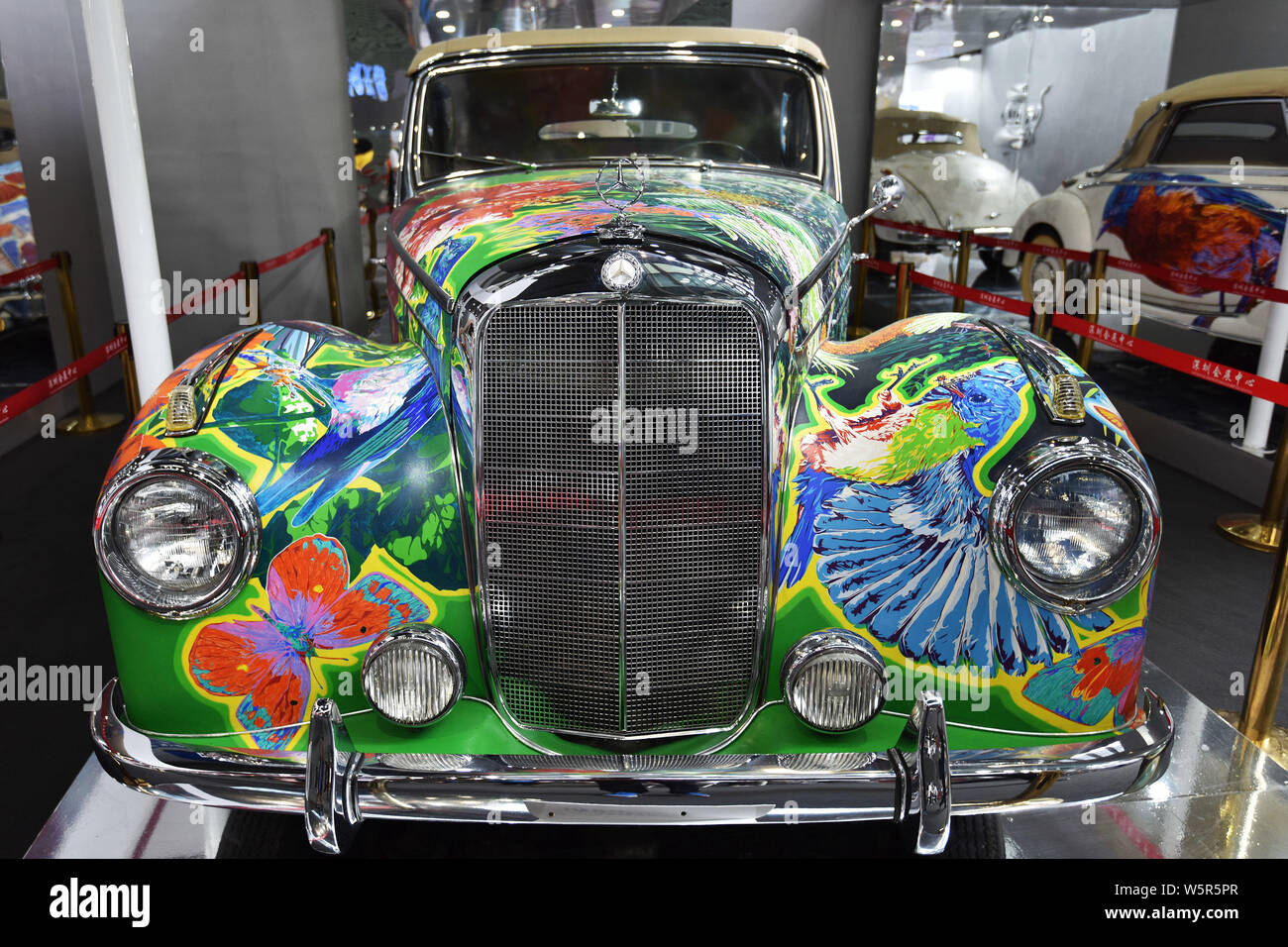 Vintage vehicles covered with colorful oil painting images are ...