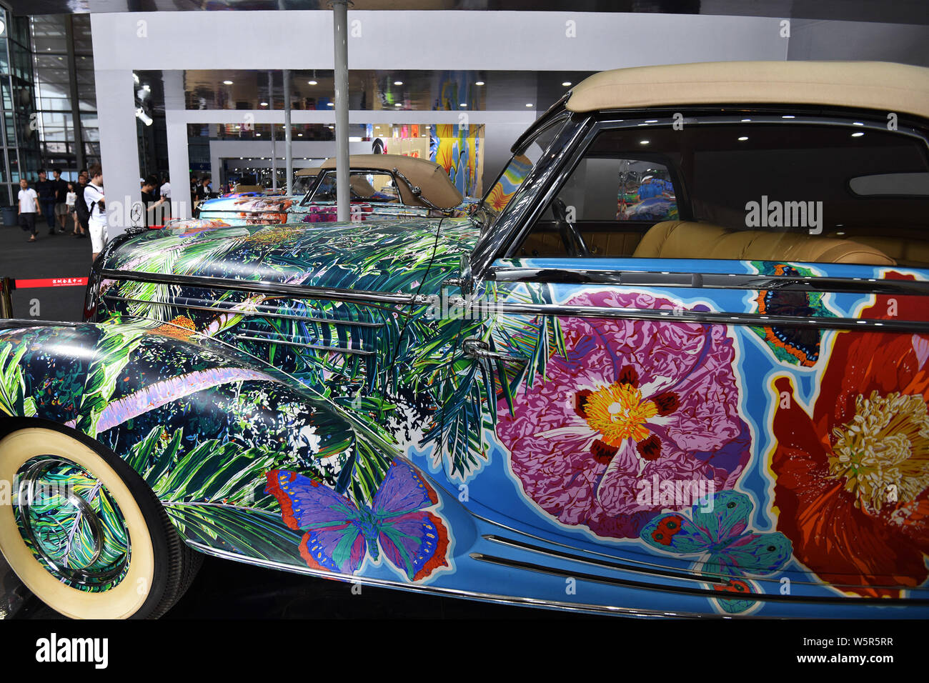Vintage vehicles covered with colorful oil painting images are ...