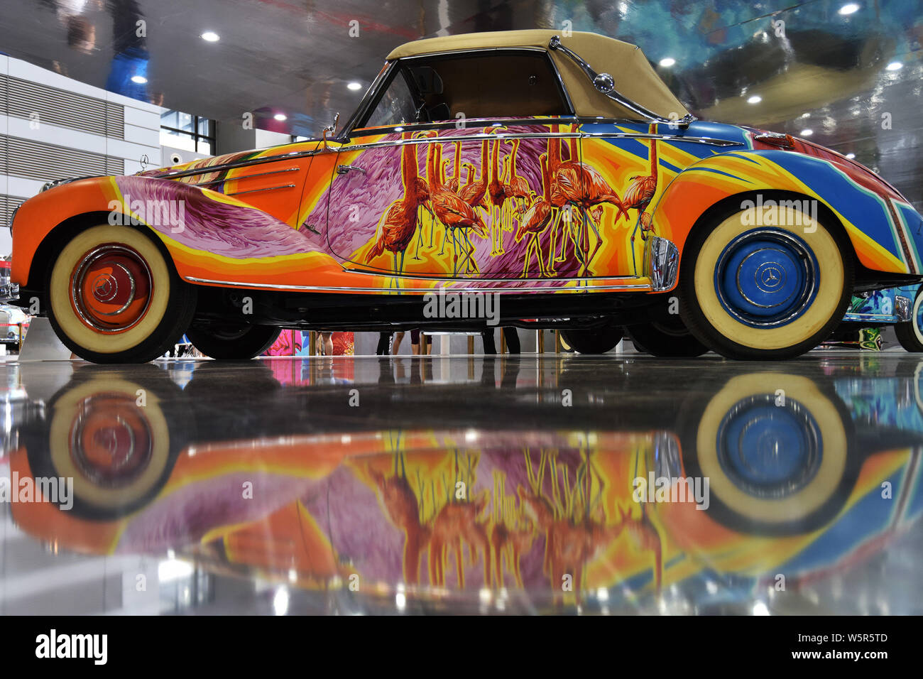 Vintage vehicles covered with colorful oil painting images are ...