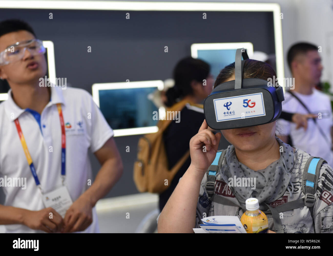 A visitor tries out a VR device via 5G network during the 2019 Beijing ...