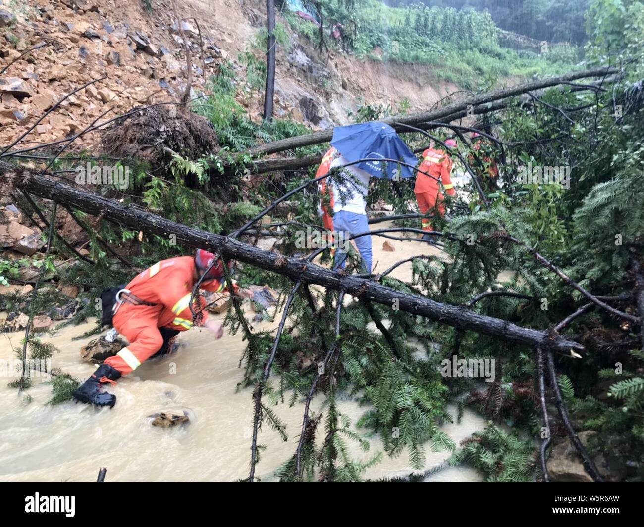 Chinese rescuers clear away mud and stones after a landslide caused by ...