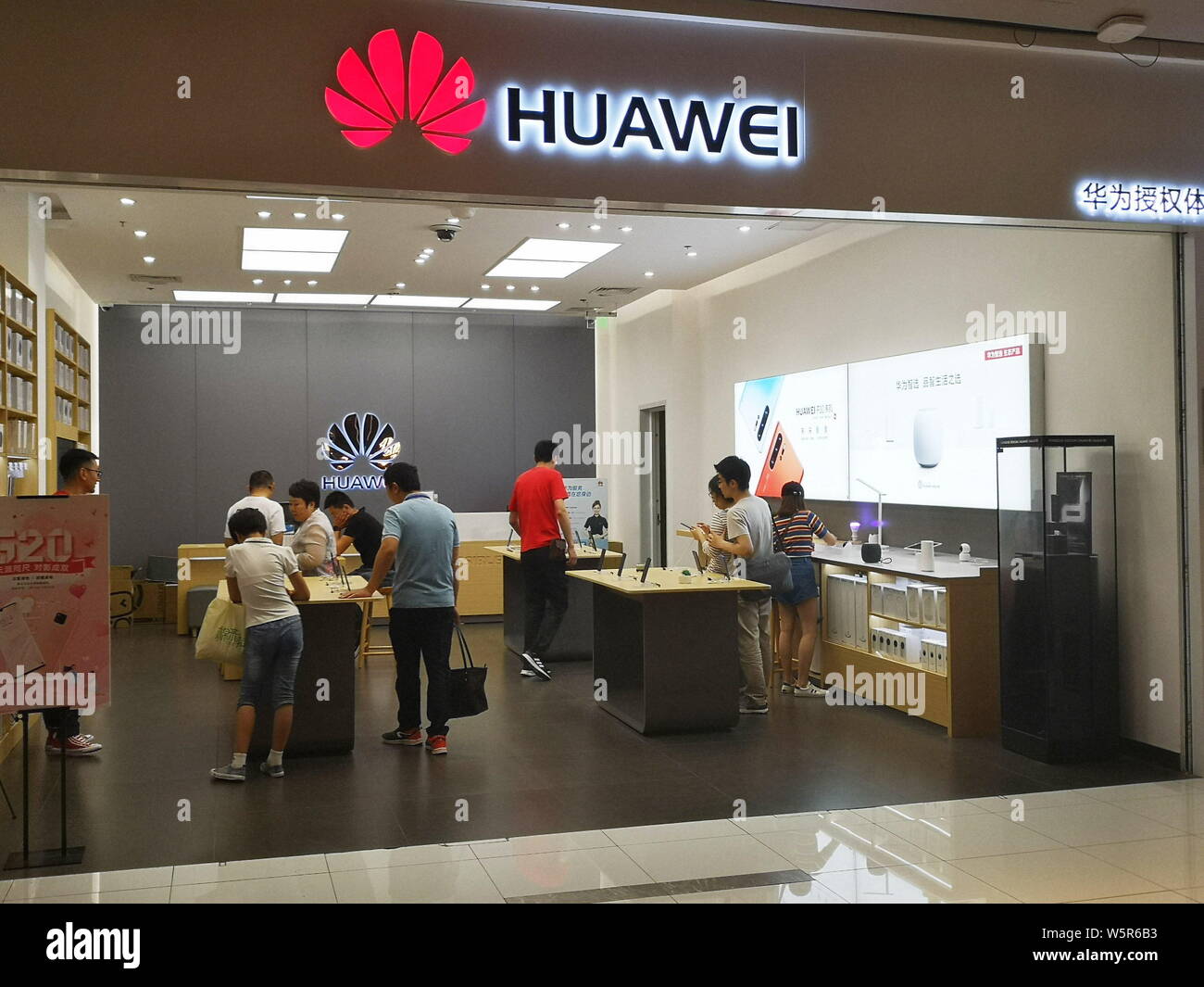 Customers shop at a store of Huawei in Beijing, China, 1 June 2019. The ...