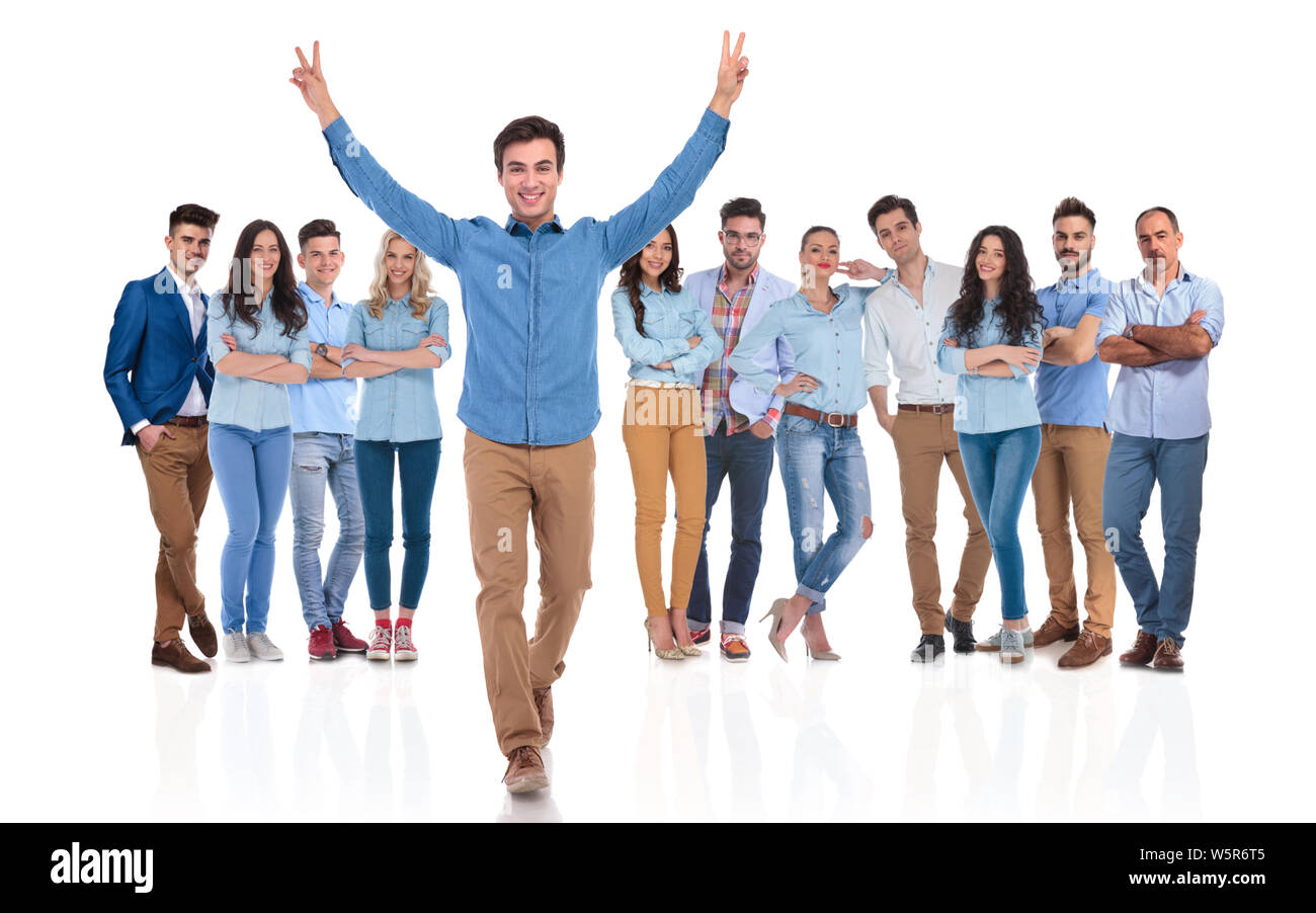 young team leader celebrating success of casual group while walking ...
