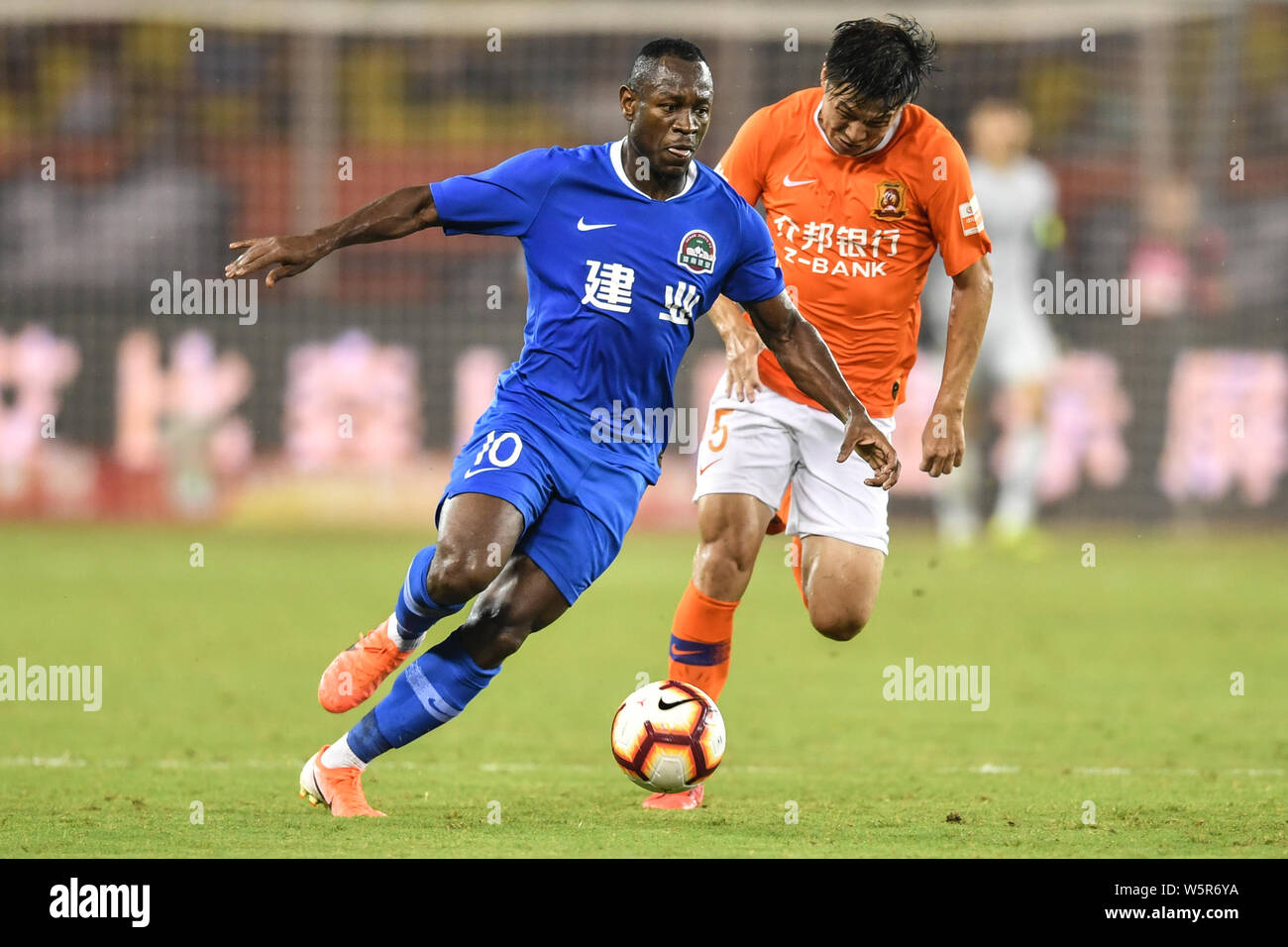 Cameroonian football player Christian Bassogog, left, of Henan Jianye ...