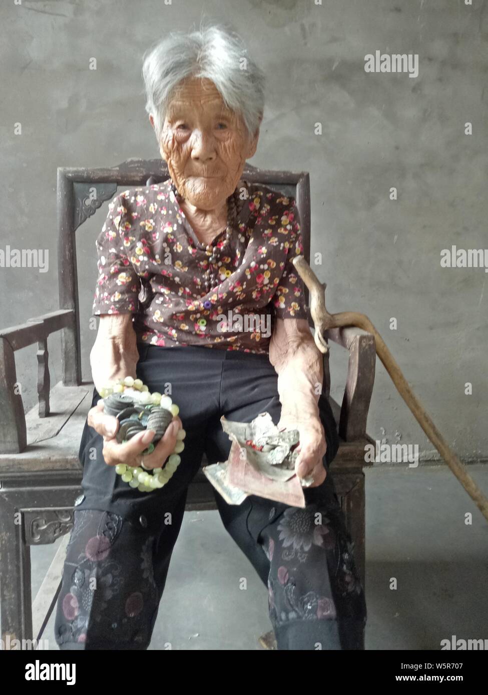 Chinese ninety-seven-year-old woman Zhang Sulan shows her dowry at home ...