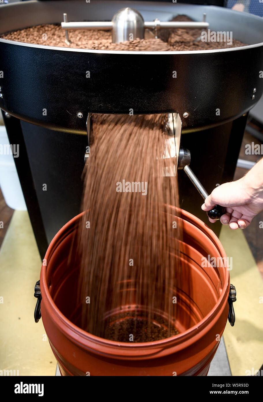 Berlin, Germany. 16th July, 2019. Philipp Reichel fills coffee 9 with ...