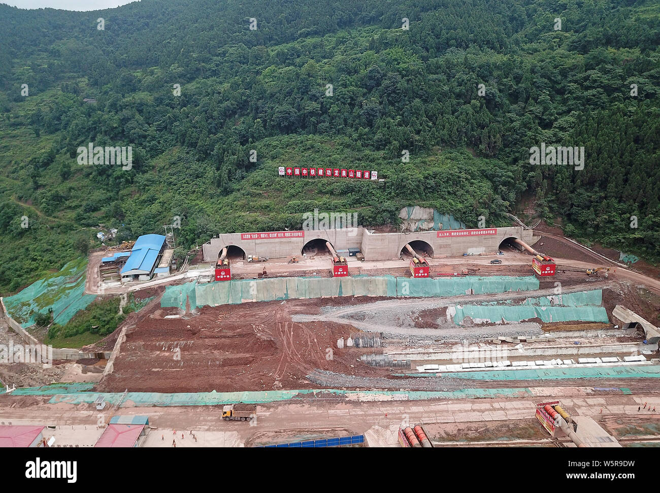 Chinese workers labor at the construction site of Longquanshan Tunnel ...