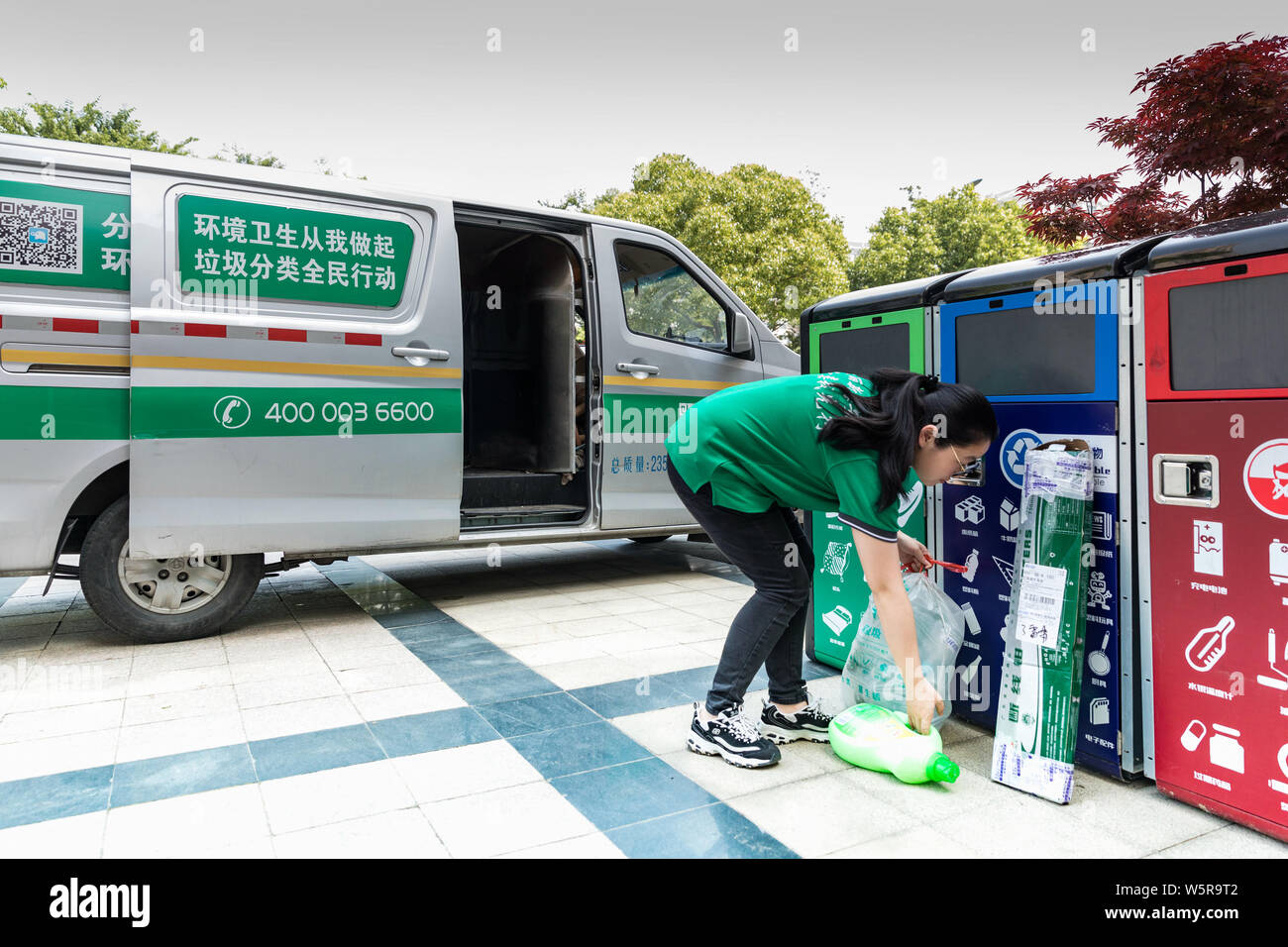 A Chinese worker take the garbage away from the garbage sorting bins in ...