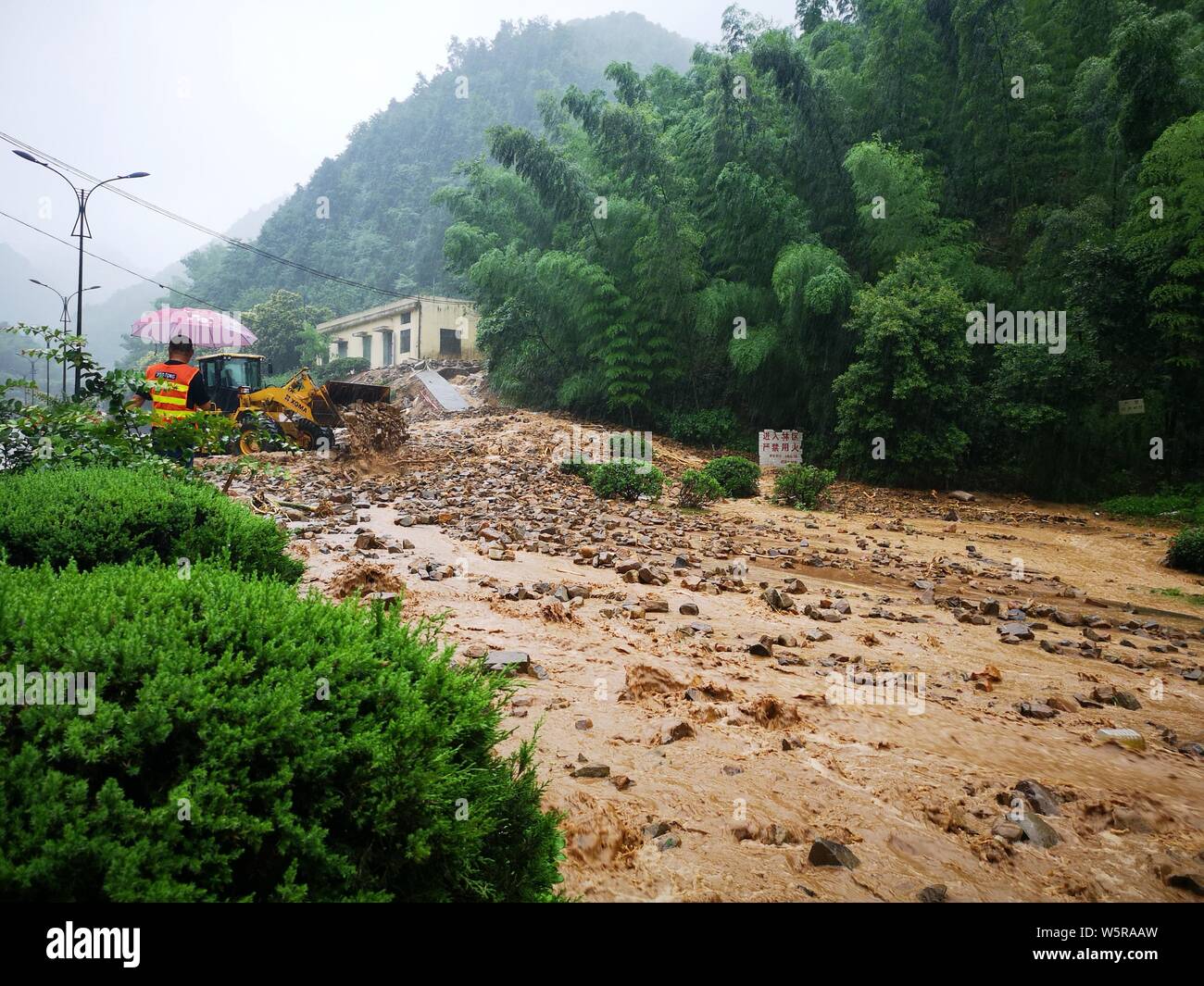 Chinese rescuers clear away mud and stones after a landslide caused by ...