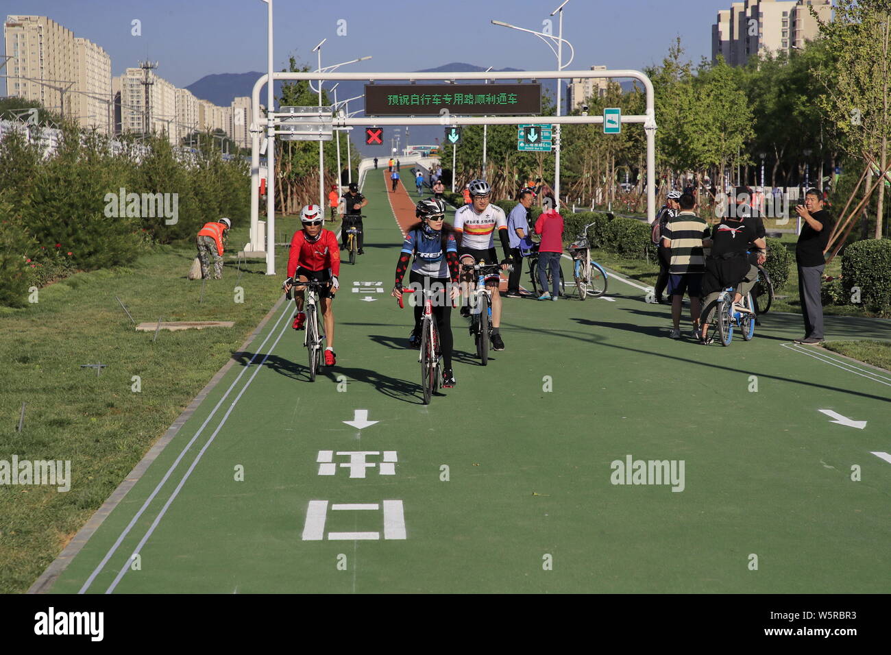 Local residents ride bikes on the first bicycle-only road, which is ...