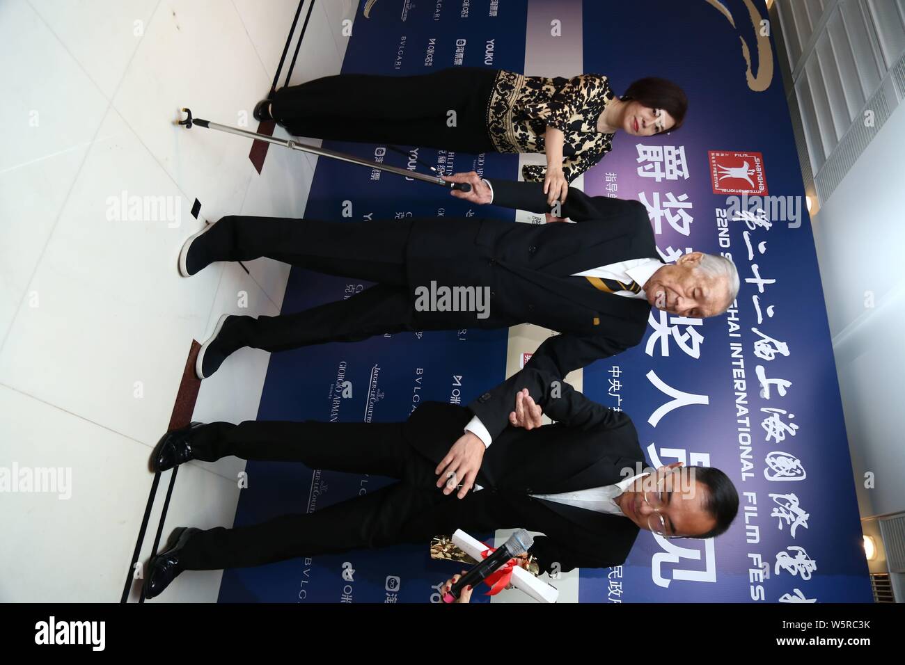 96-year-old Chinese actor Chang Feng poses with his trophy after ...