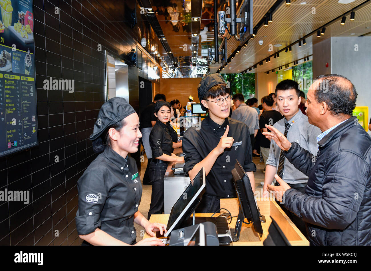 Customers shop at the "Experience of the Future" restaurant of McDonald ...