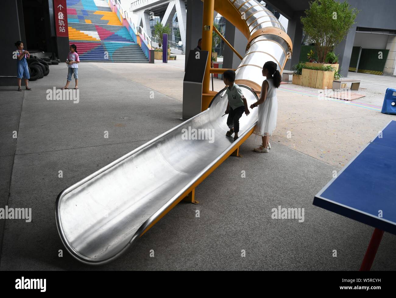 A child tries out a 10-meter-high spiral slide from the first floor of ...
