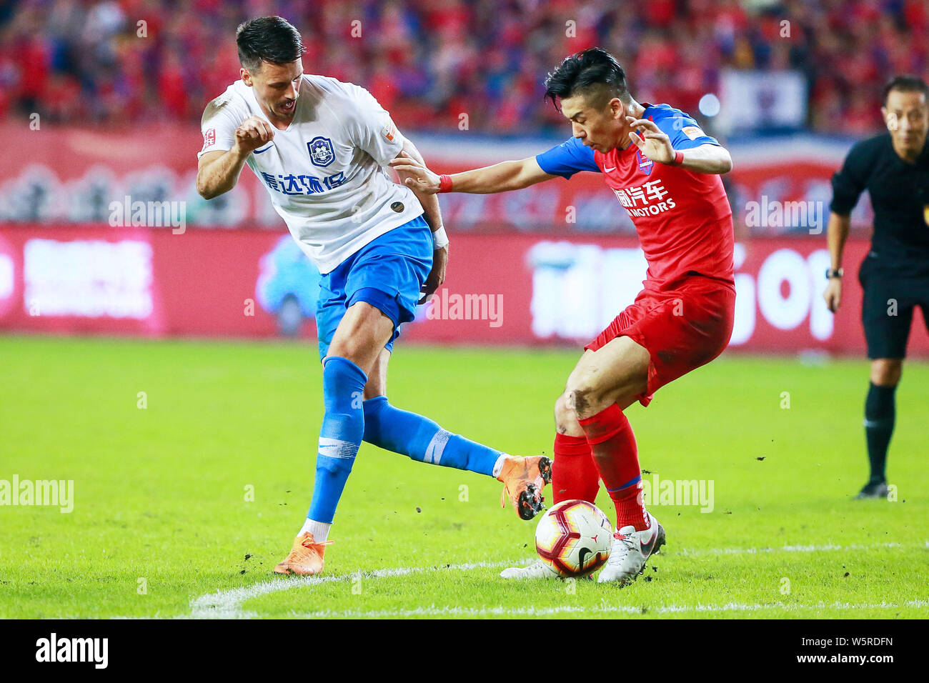 German football player Sandro Wagner, left, of Tianjin TEDA passes the ...