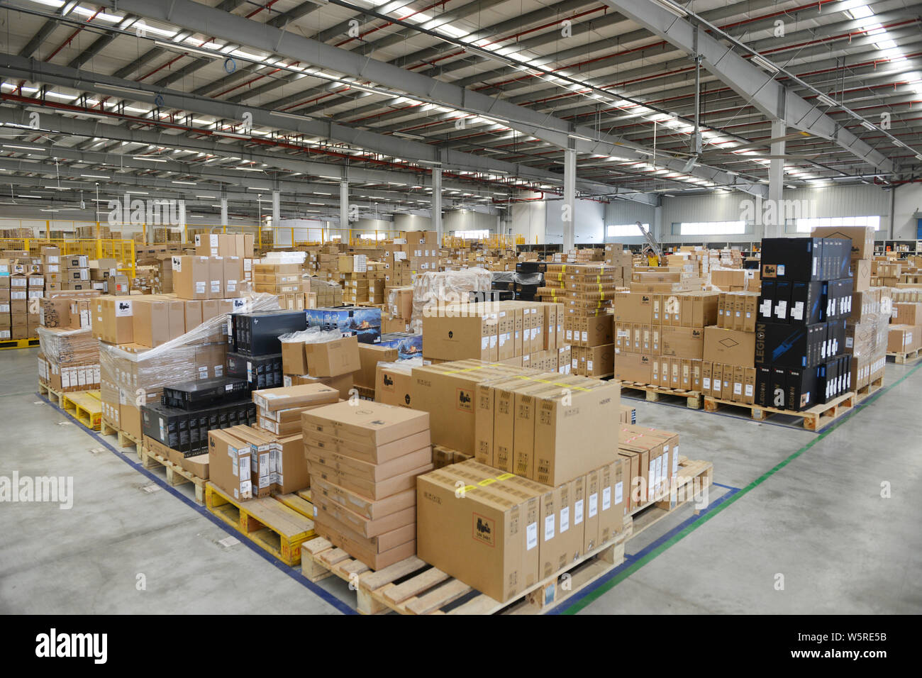 Chinese workers sort out parcels at the largest smart logistics base in ...