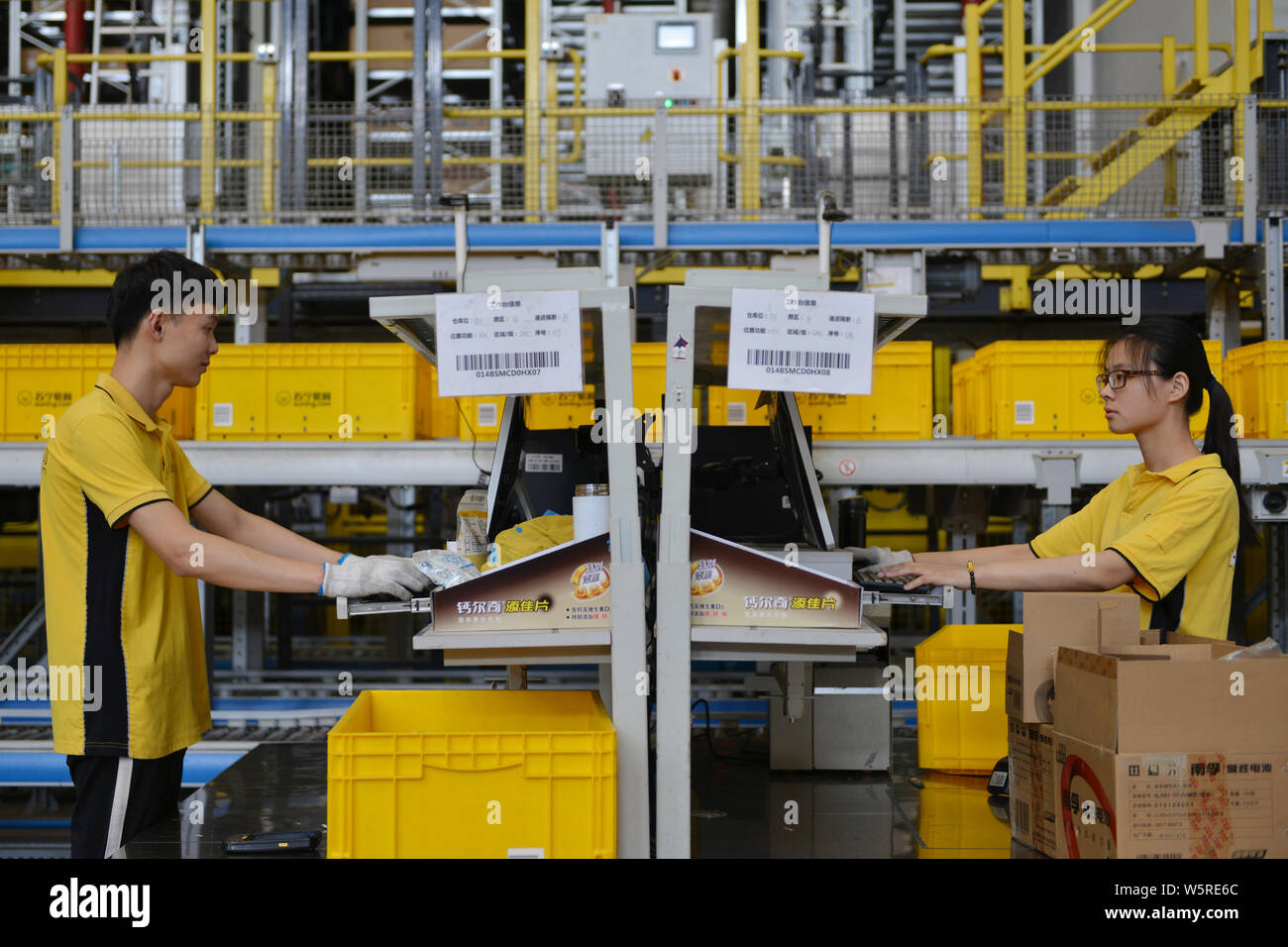 Chinese workers sort out parcels at the largest smart logistics base in ...