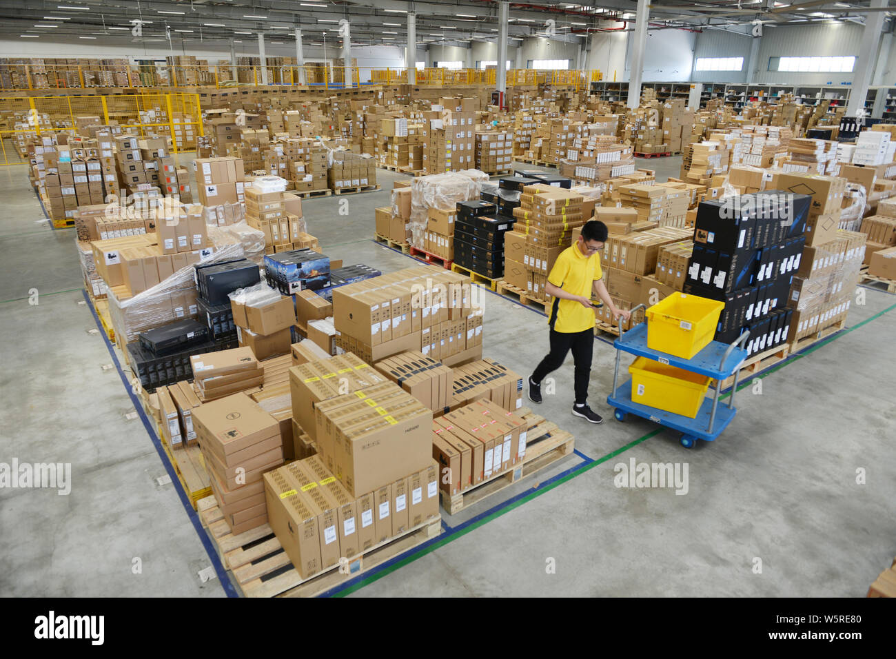 Chinese workers sort out parcels at the largest smart logistics base in ...