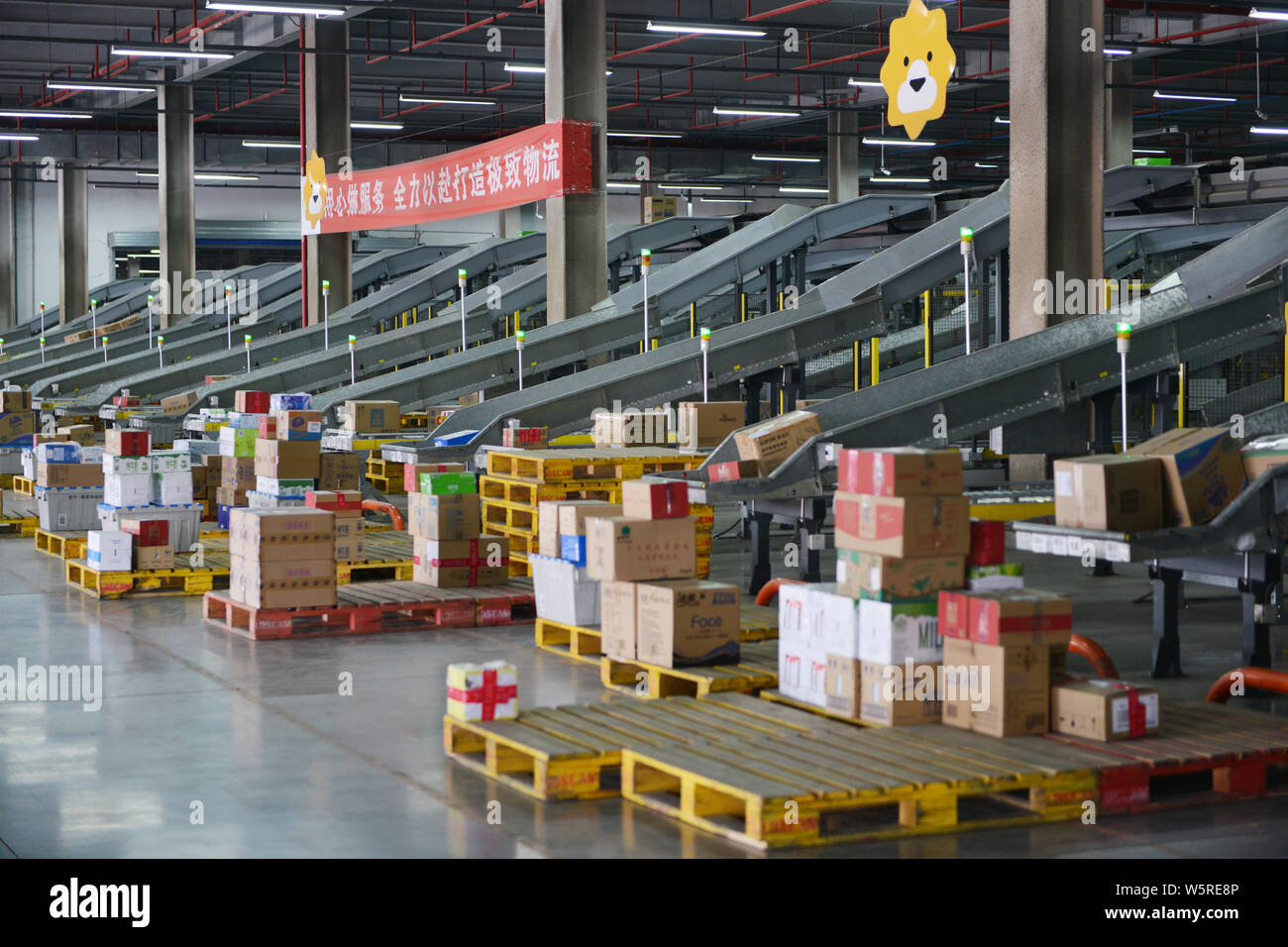 Chinese workers sort out parcels at the largest smart logistics base in ...
