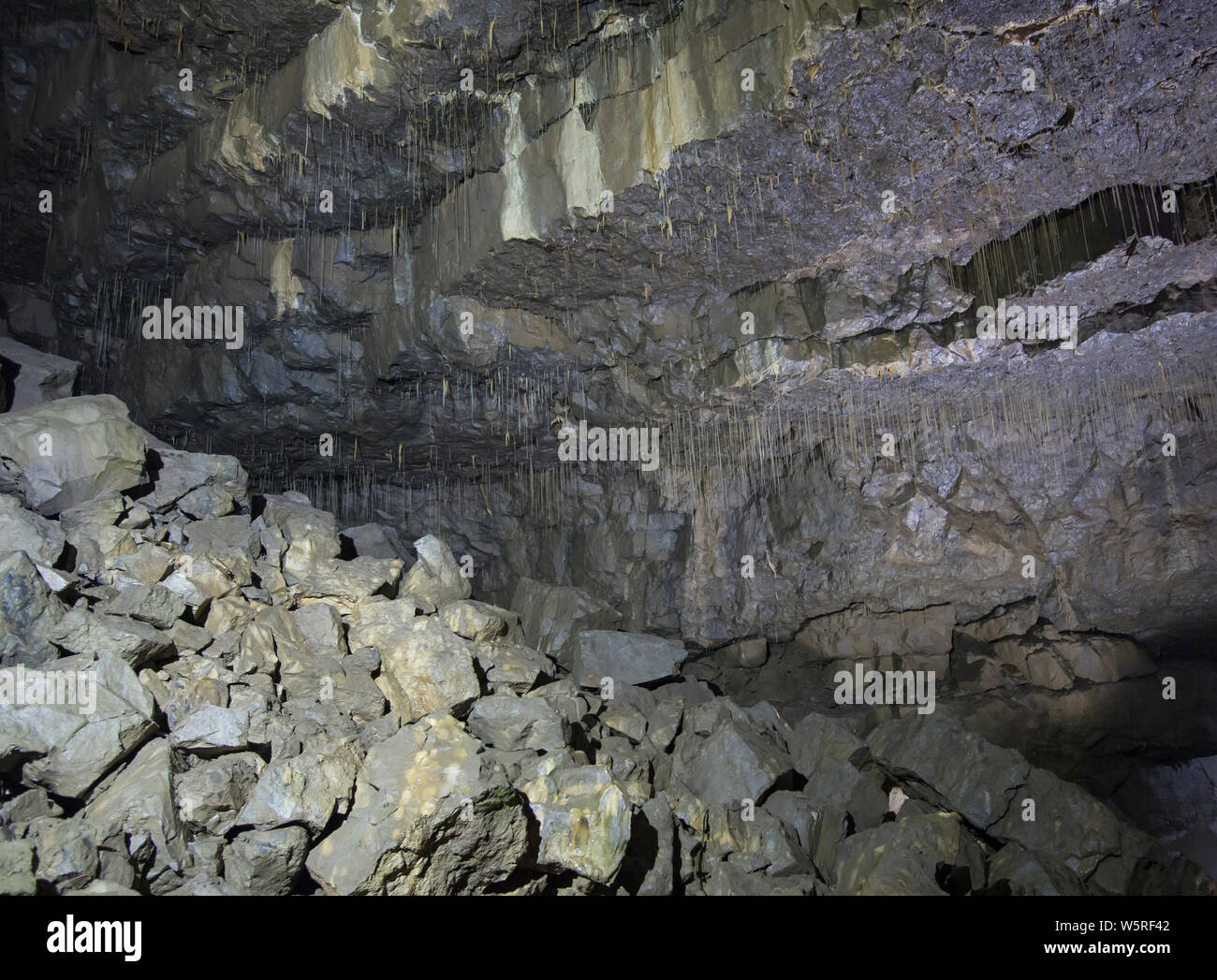 Inside interior of a large underground cave cavern with calcite ...