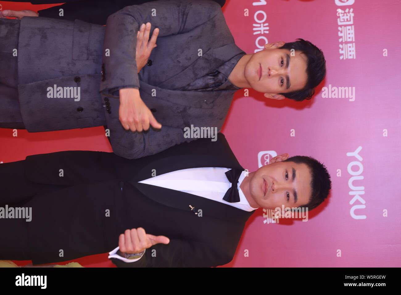 Taiwanese actor Eddie Peng, left, and Chinese actor Wang Yanlin arrive on the red carpet for the ...
