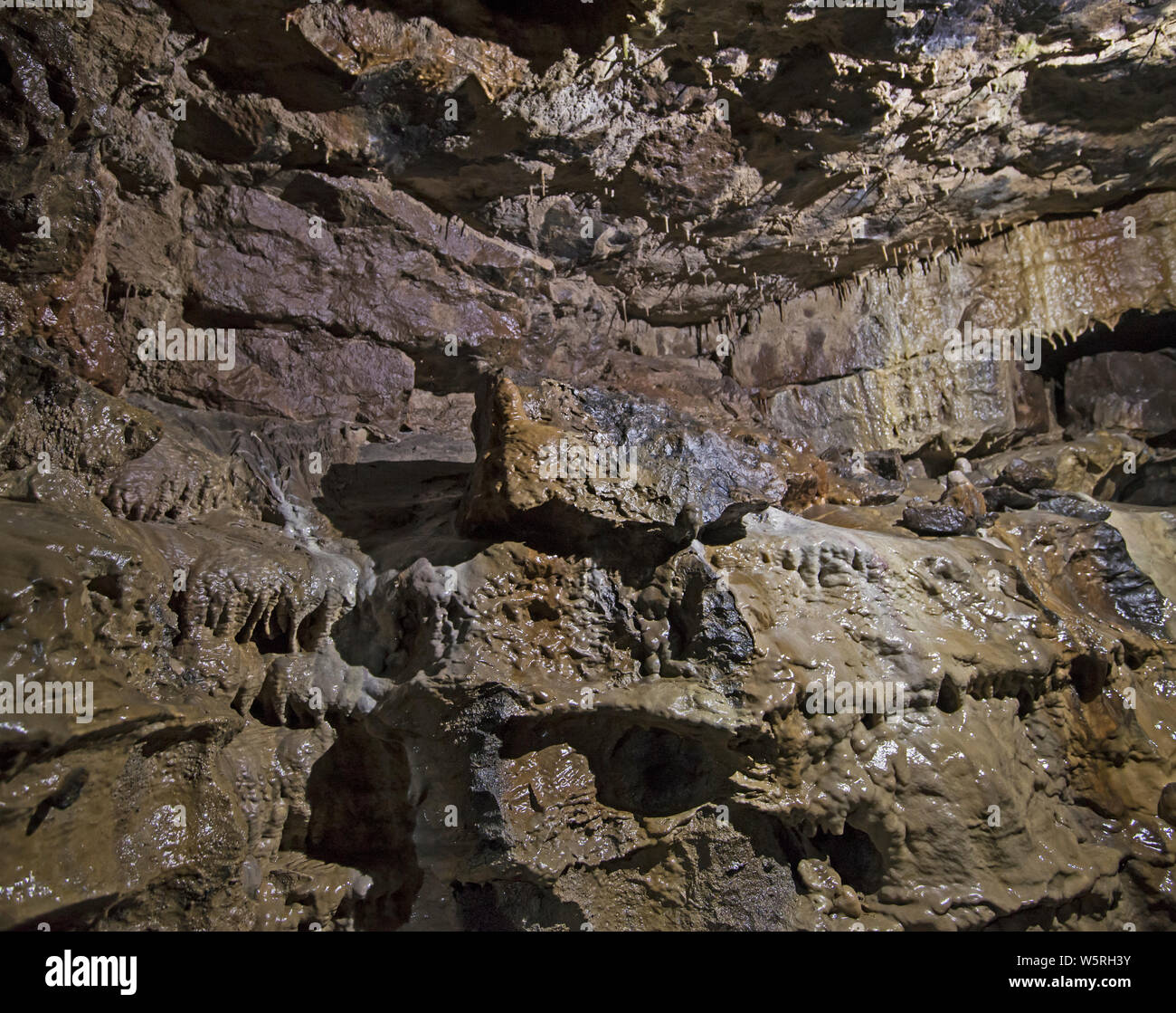 Inside interior of a large underground cave cavern with calcite ...