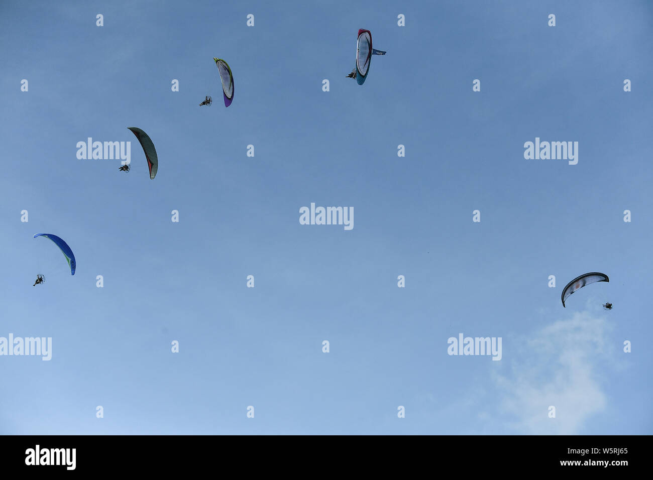 A wingsuit flyer jumps from a high place to glide through the air ...